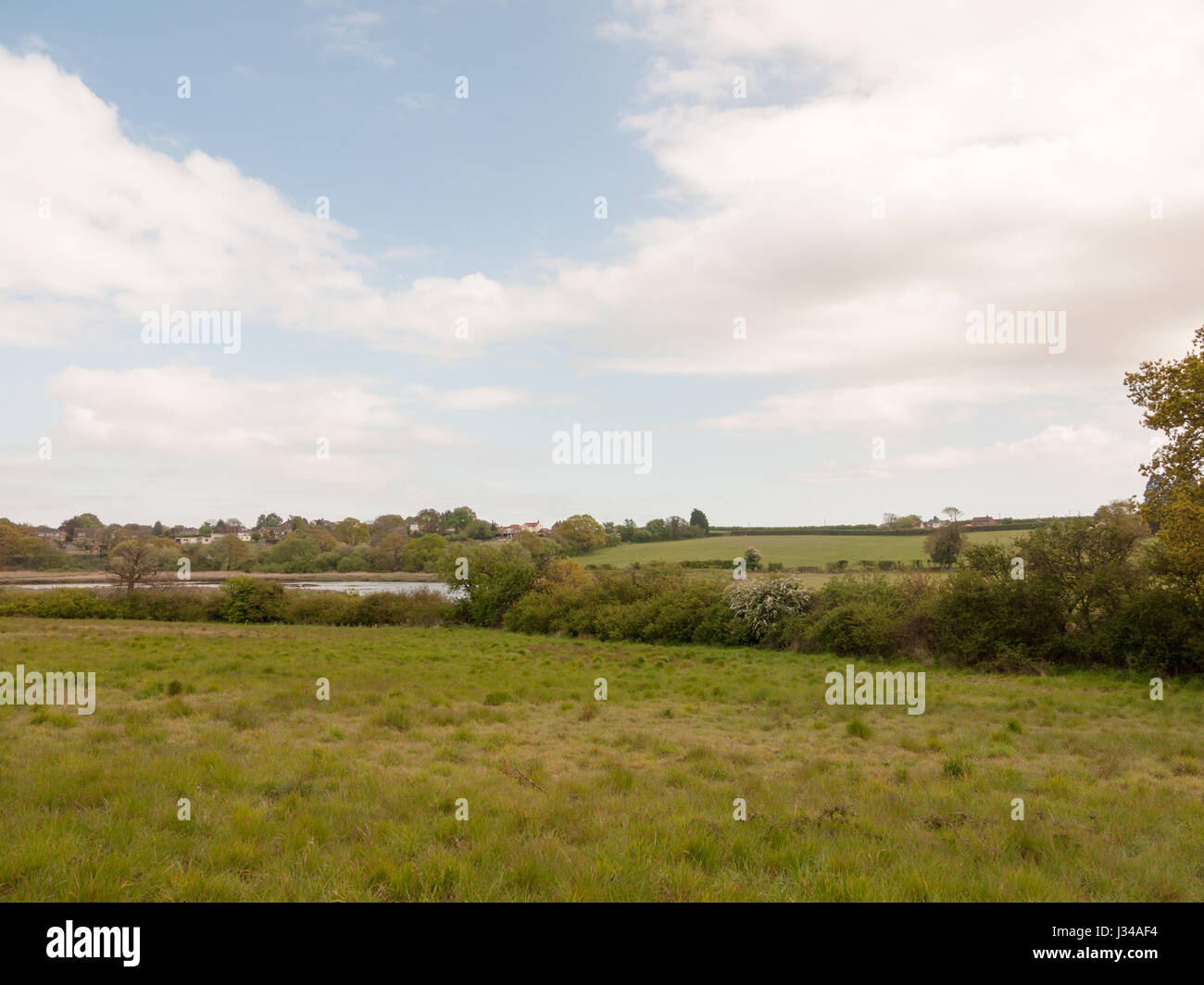 blue and cloudy countryside scene outside in an open field Stock Photo ...