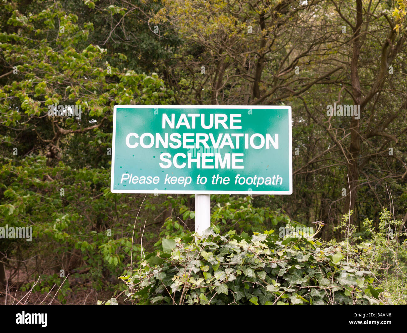 a green sign outside saying nature conservation scheme for graphic ...