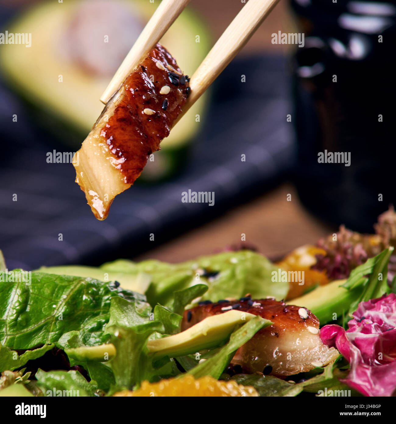 Eating salad with eel Stock Photo - Alamy