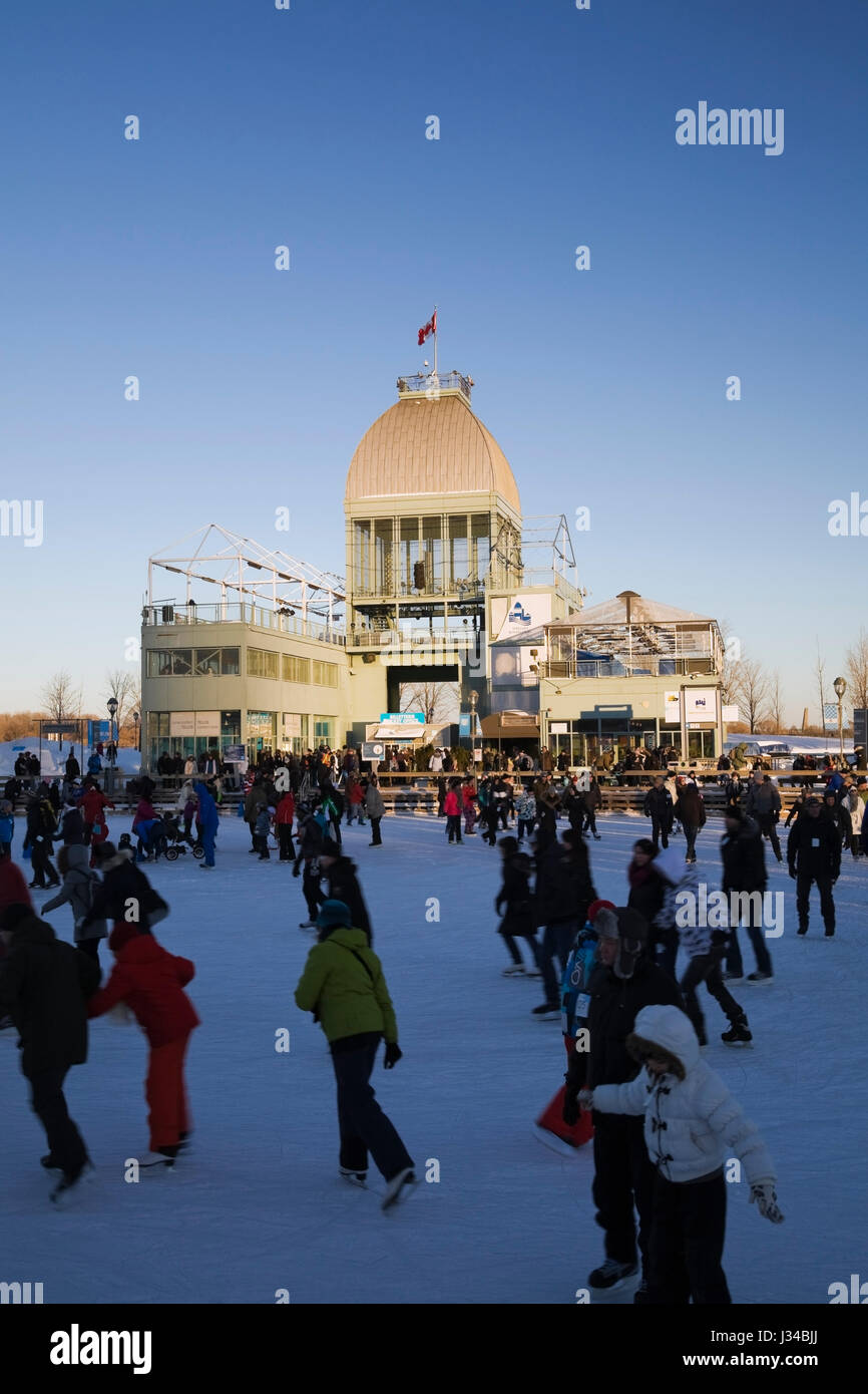Silhouetted ice skaters at the Old Port skating rink, Old Montreal ...