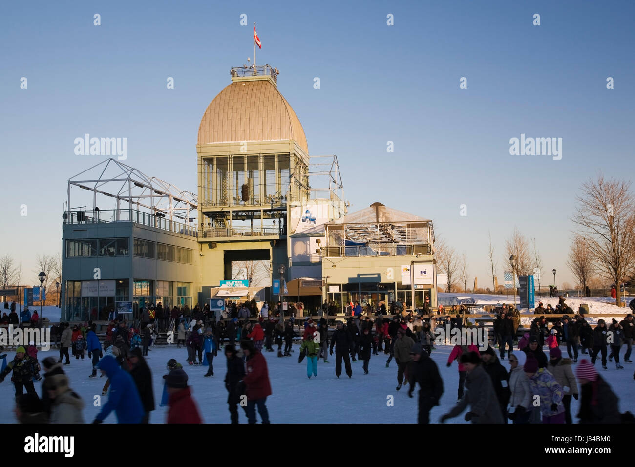 Silhouetted ice skaters at the Old Port skating rink, Old Montreal ...