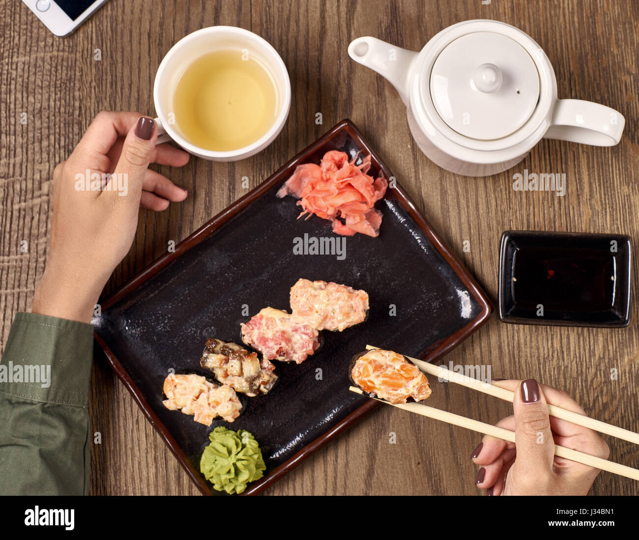 Eating sushi with bamboo sticks Stock Photo - Alamy