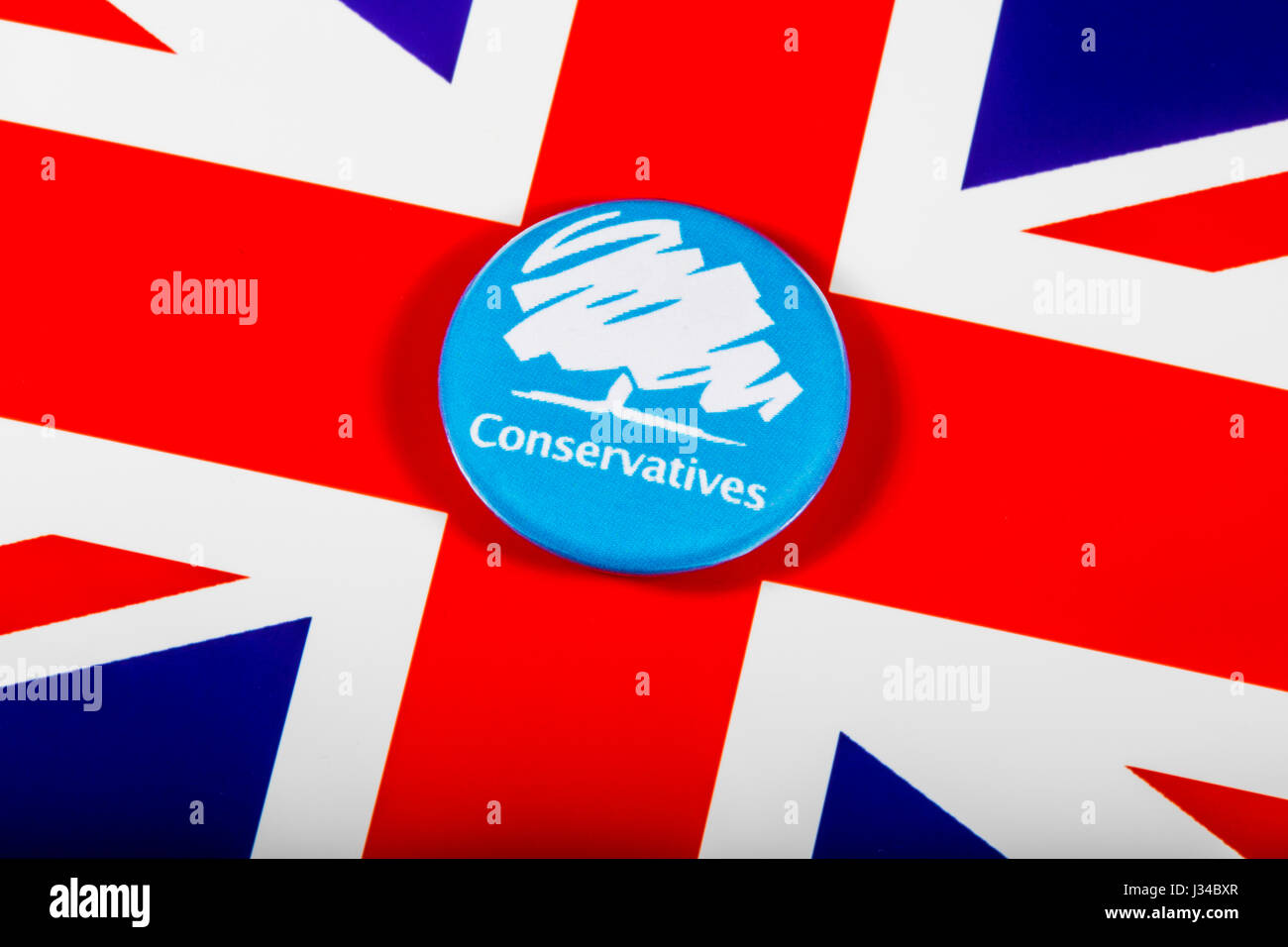 LONDON, UK - MAY 2ND 2017: A Conservative Party pin badge over the UK ...