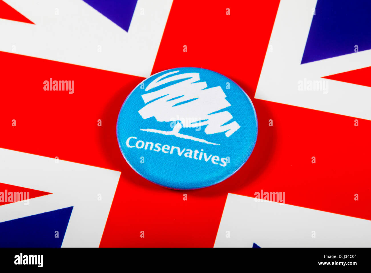 LONDON, UK - MAY 2ND 2017: A Conservative Party pin badge over the UK ...