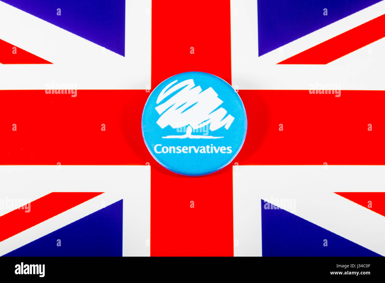 LONDON, UK - MAY 2ND 2017: A Conservative Party pin badge over the UK ...