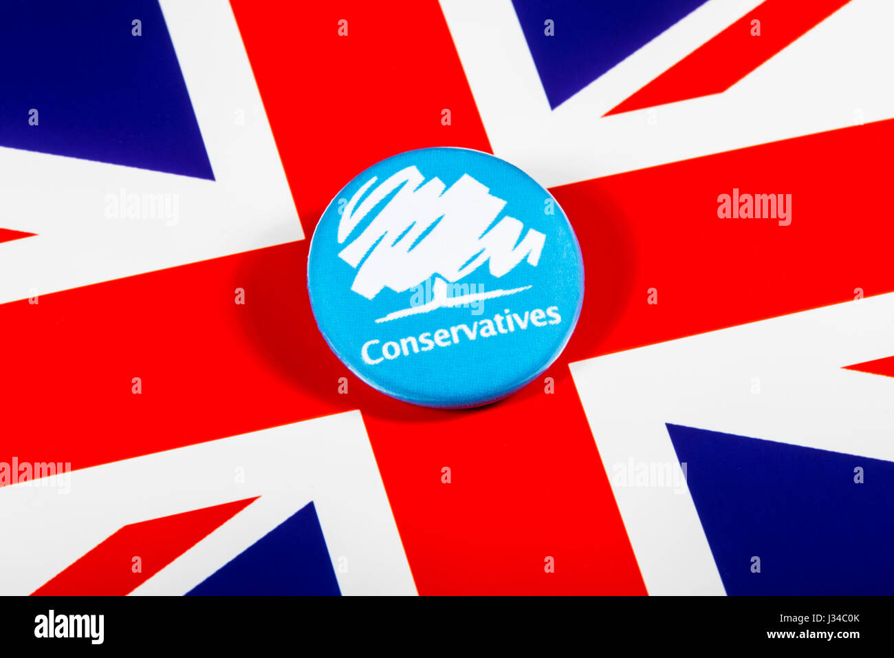 LONDON, UK - MAY 2ND 2017: A Conservative Party pin badge over the UK ...