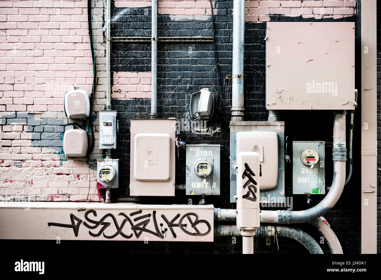 Electric utility meters on a wall with graffiti in Austin Texas USA ...
