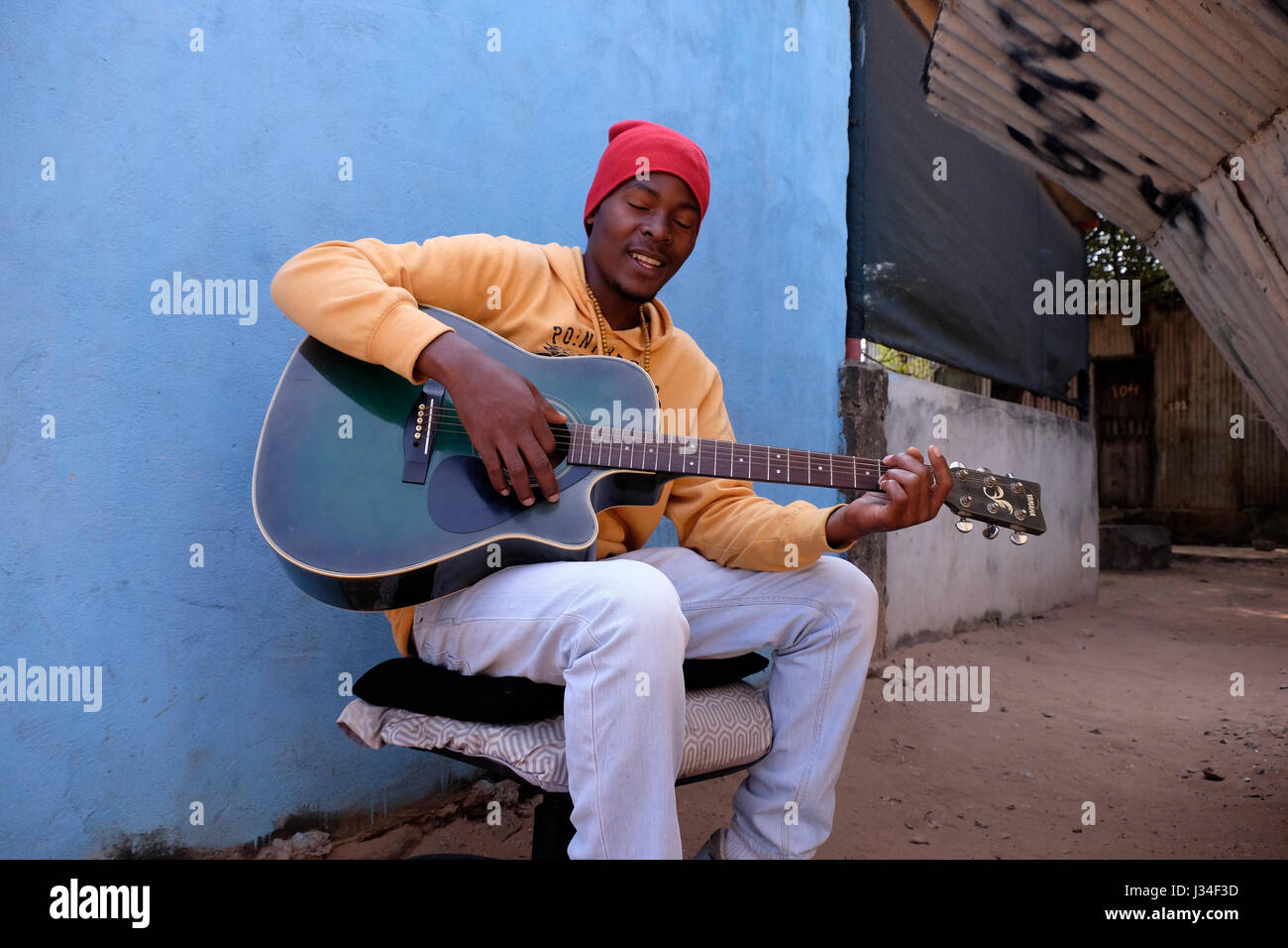 A young rapper playing the guitar in Barrio da Mafalala a poor slum of ...