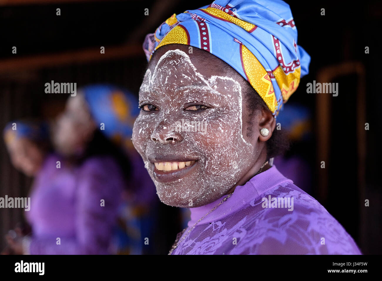 A woman in traditional clothing with her face covered with a natural ...