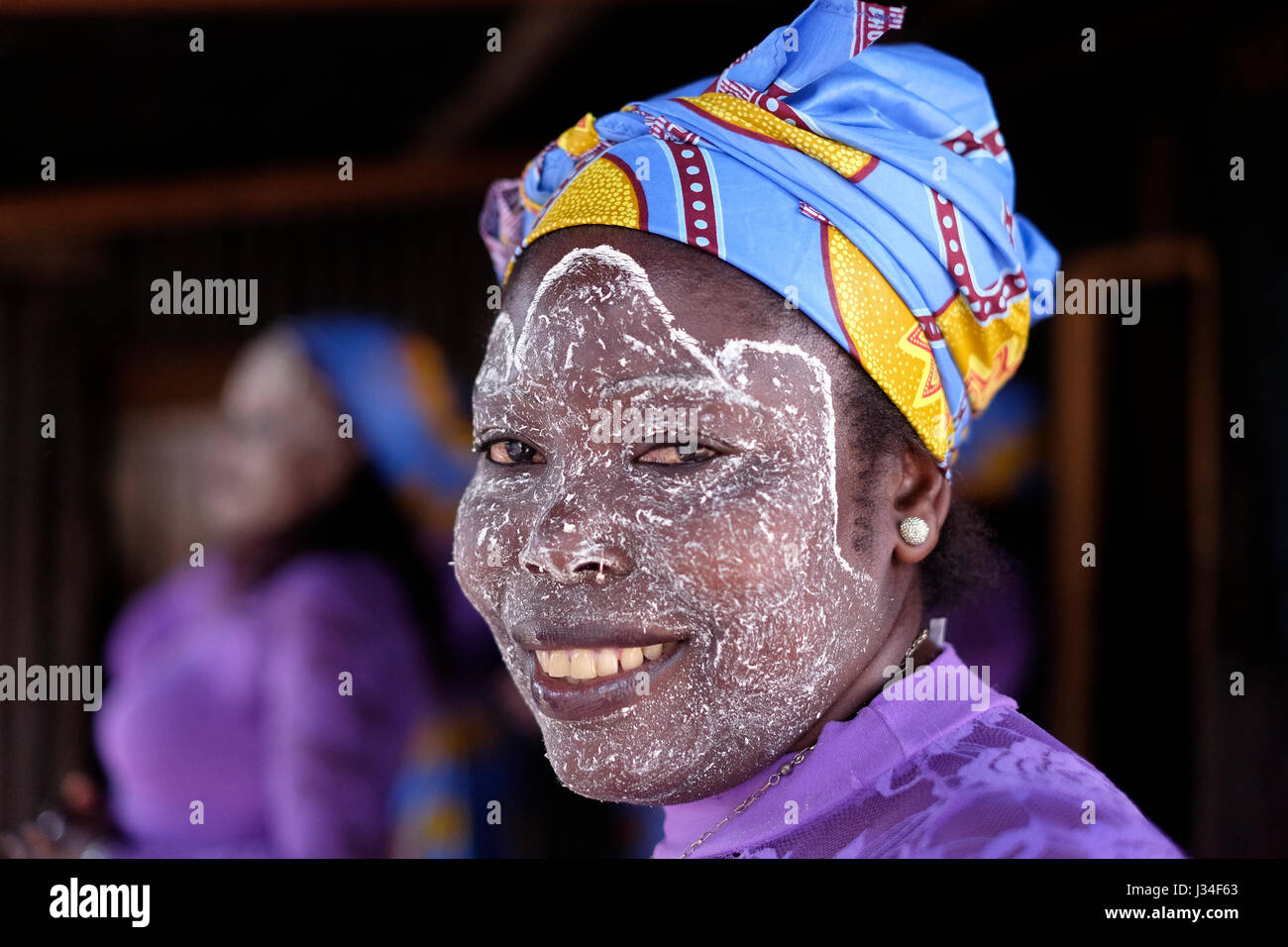 A woman in traditional clothing with her face covered with a natural ...
