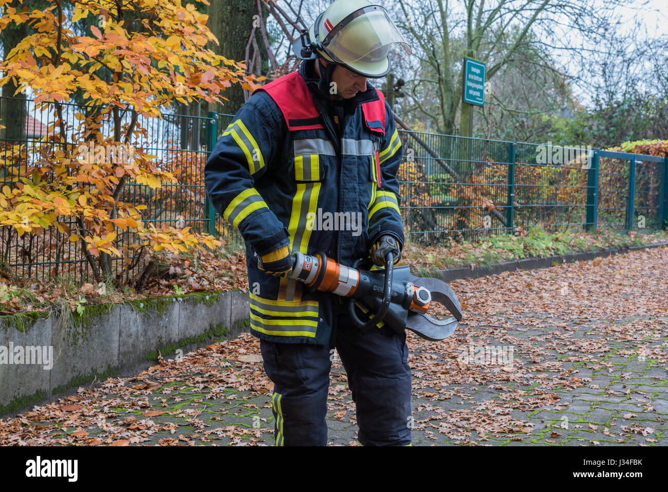 German firefighter in action with pliers for emergency use Stock Photo ...