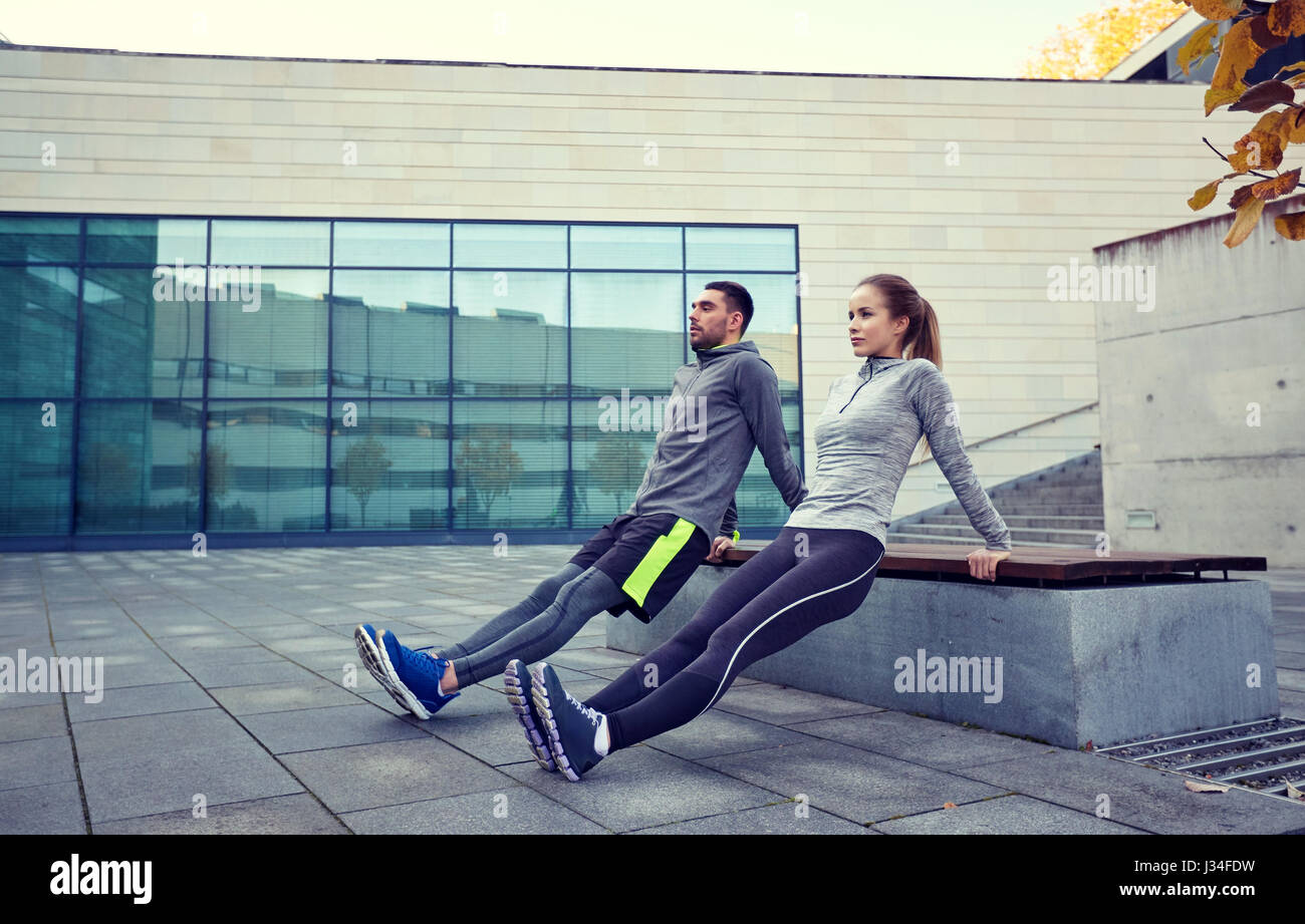 couple doing triceps dip exercise outdoors Stock Photo - Alamy