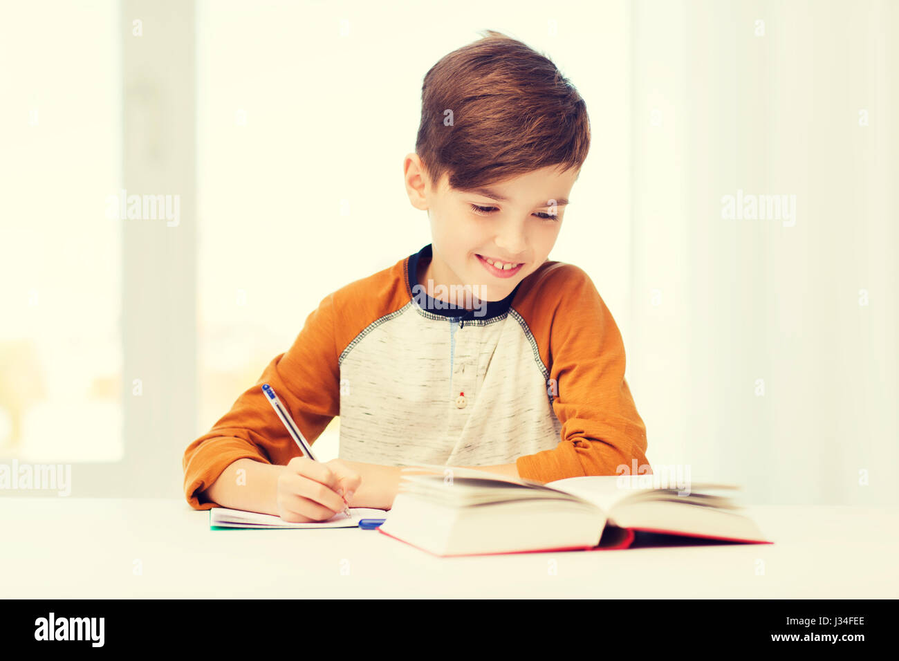 Happy pre teen boy studying hi-res stock photography and images - Alamy