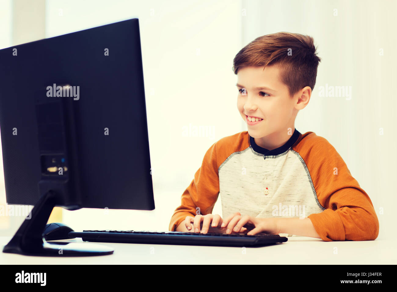 smiling boy with computer at home Stock Photo - Alamy