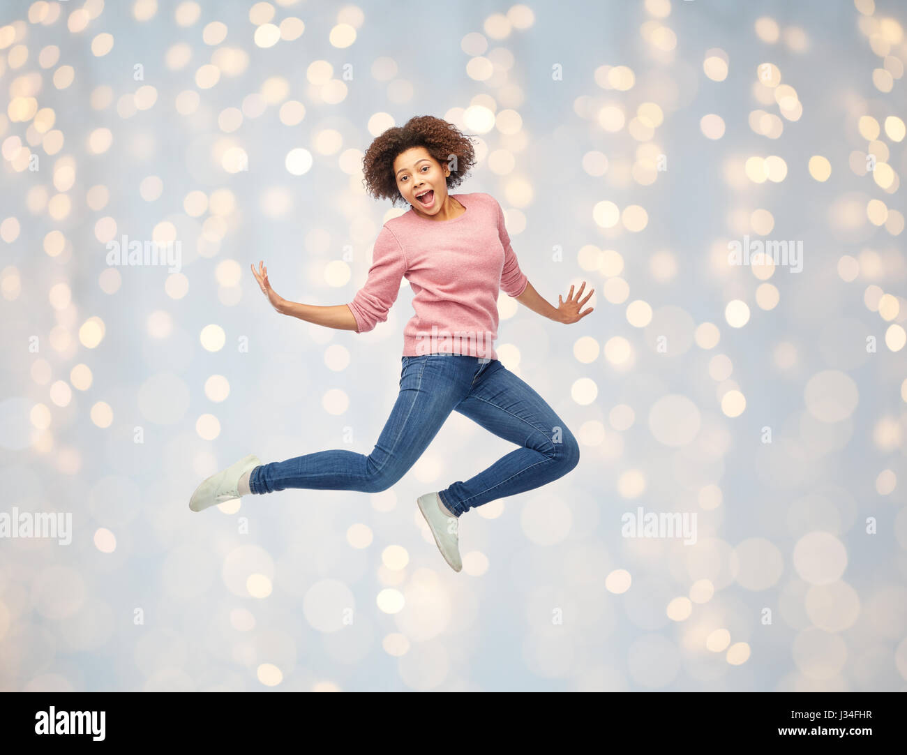happy african american woman jumping over white Stock Photo - Alamy