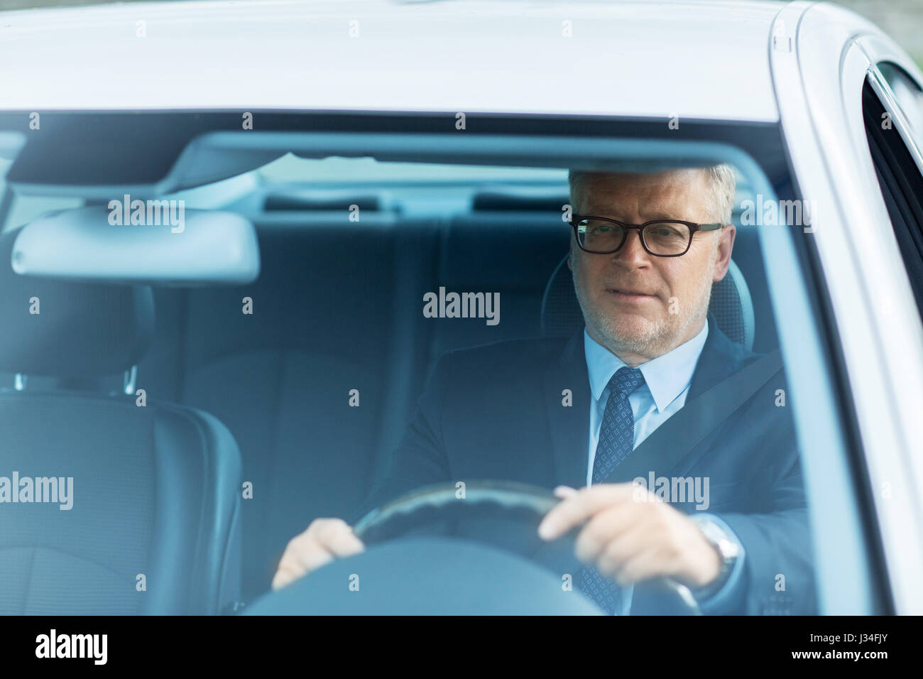 happy senior businessman driving car Stock Photo - Alamy