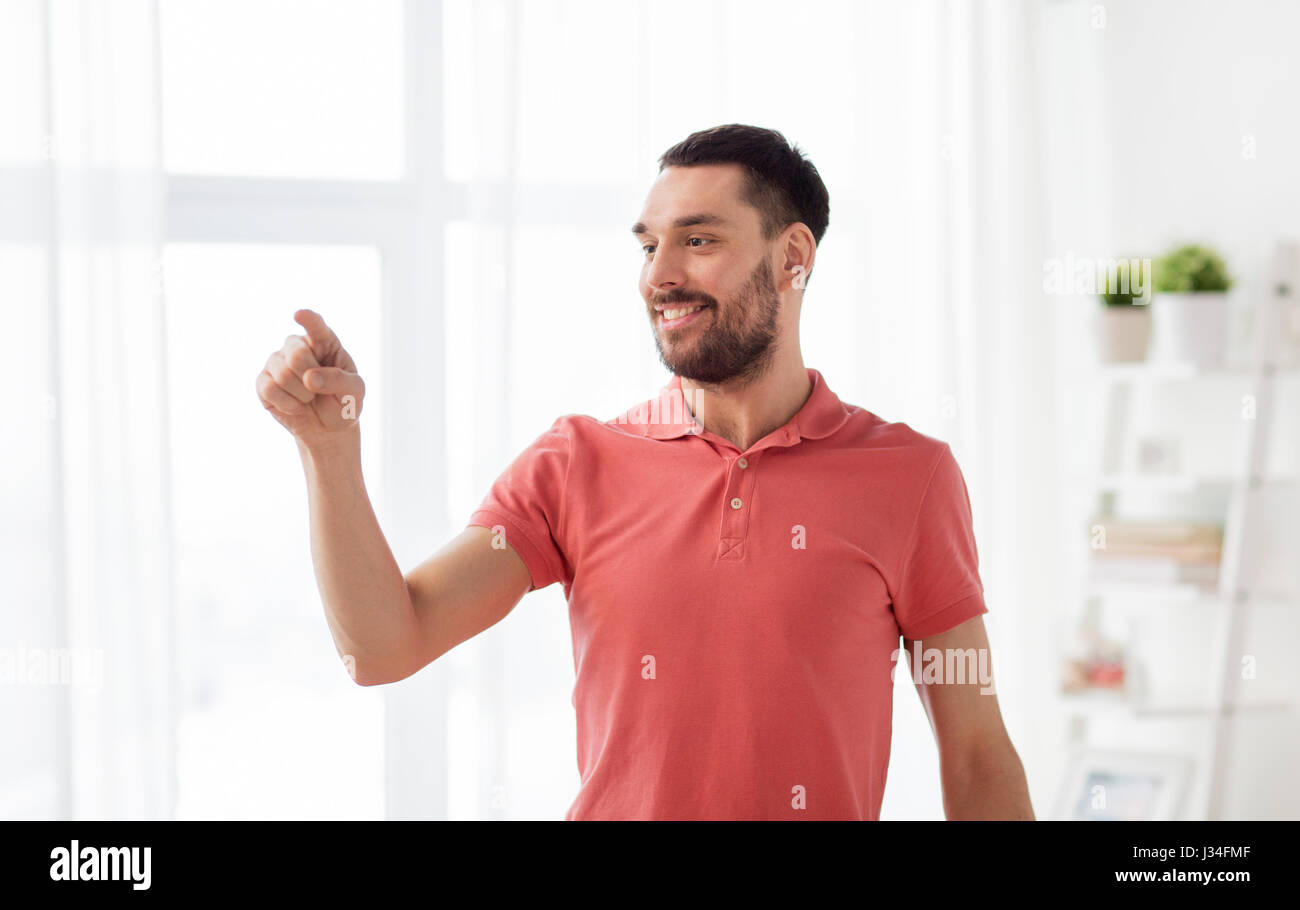 happy man touching something imaginary at home Stock Photo - Alamy