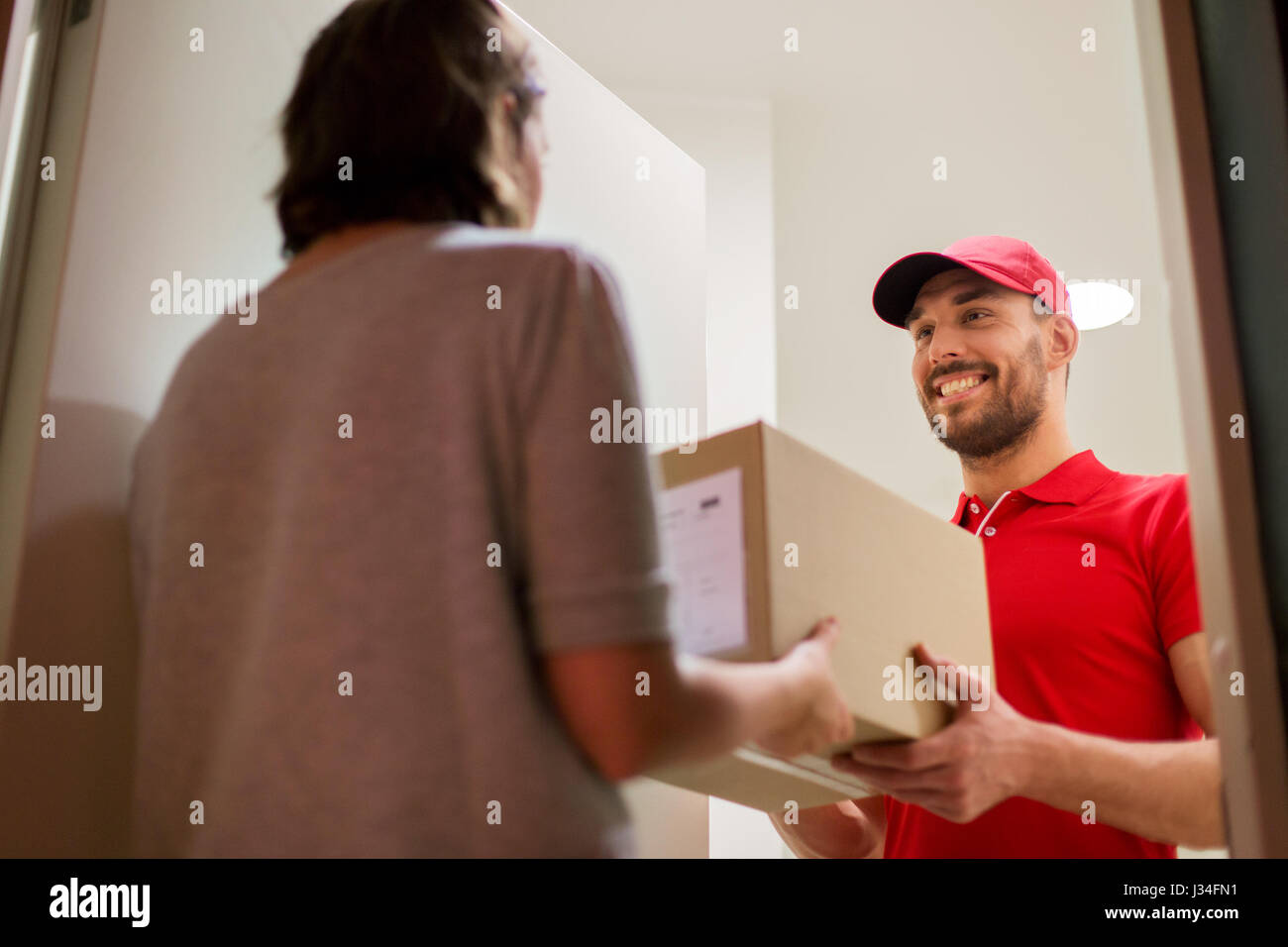 happy delivery man giving parcel box to customer Stock Photo - Alamy