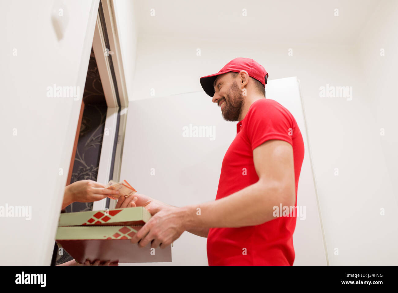 man delivering pizza to customer and taking money Stock Photo - Alamy