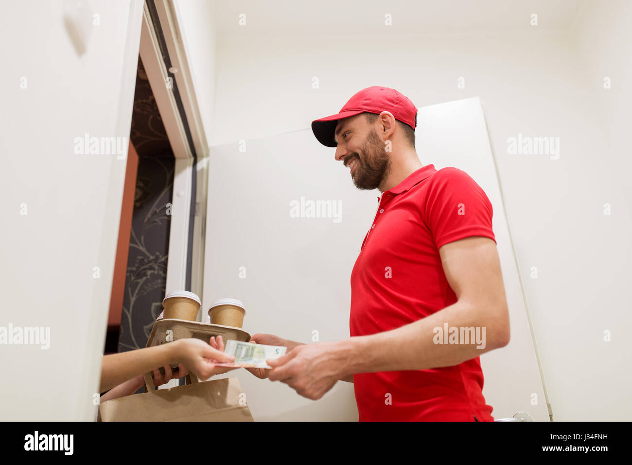 man delivering coffee and food to customer home Stock Photo - Alamy