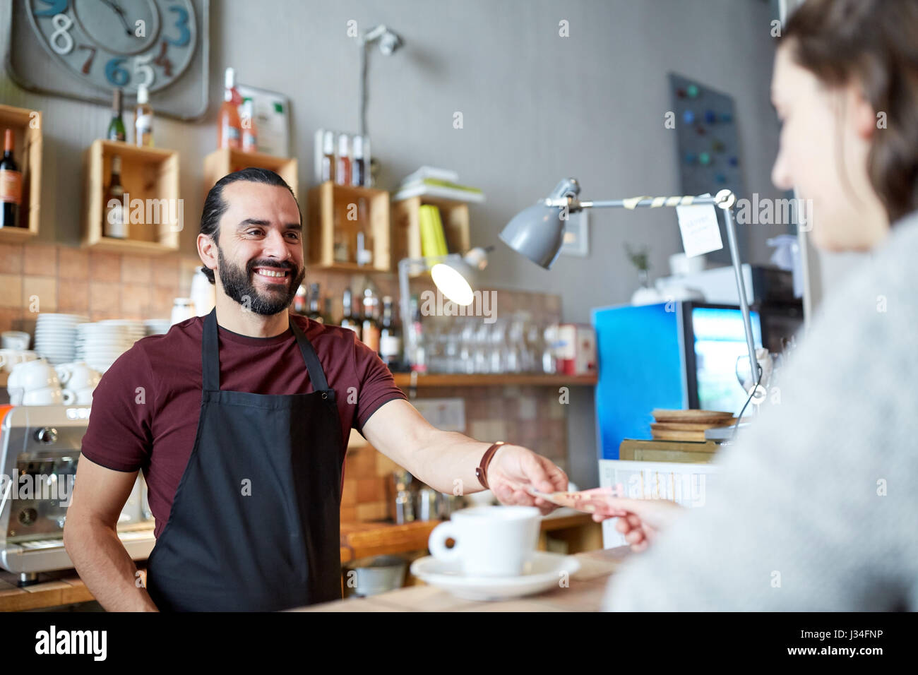 man or waiter serving customer at coffee shop Stock Photo - Alamy