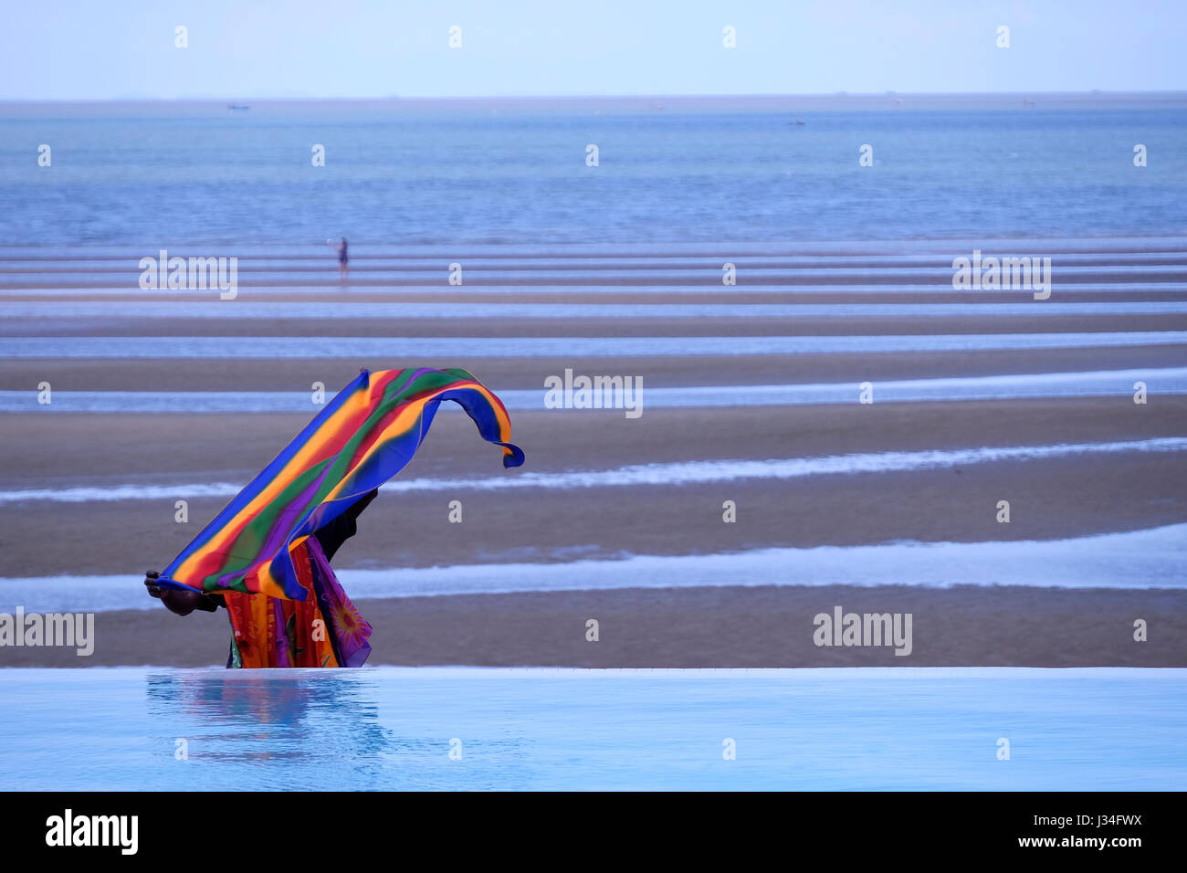 A peddler shows a capulana also spelled "Kapulana," a type of a sarong ...