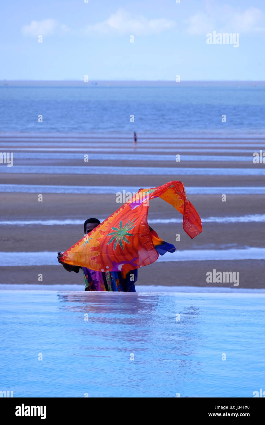 A peddler shows a capulana also spelled "Kapulana," a type of a sarong ...