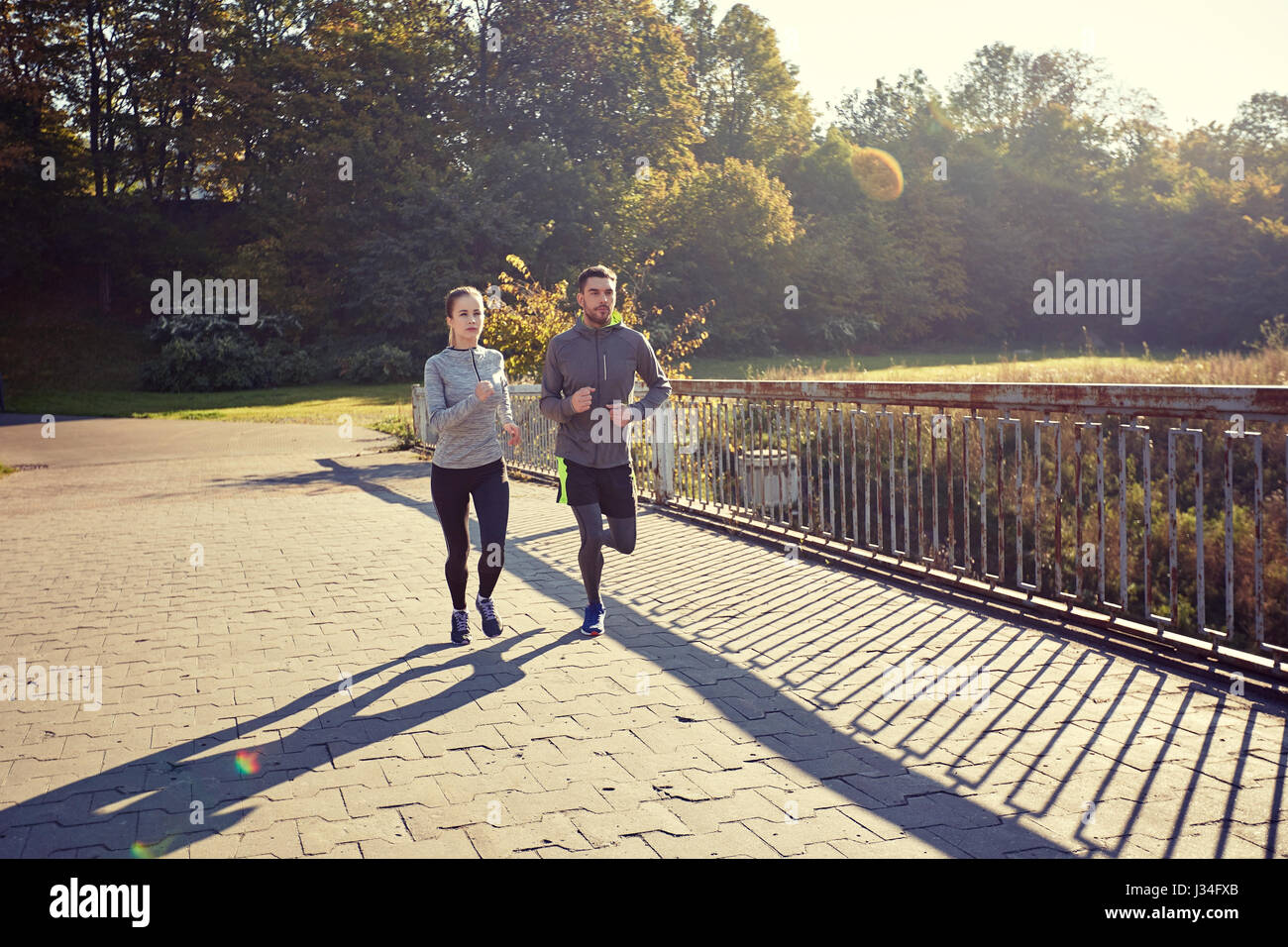 happy couple running outdoors Stock Photo - Alamy