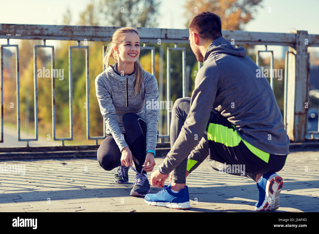 Woman tying up shoelaces hi-res stock photography and images - Alamy