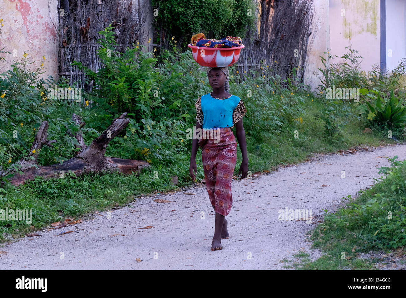 A young woman walks in Ibo island one of the islands in Quirimbas ...