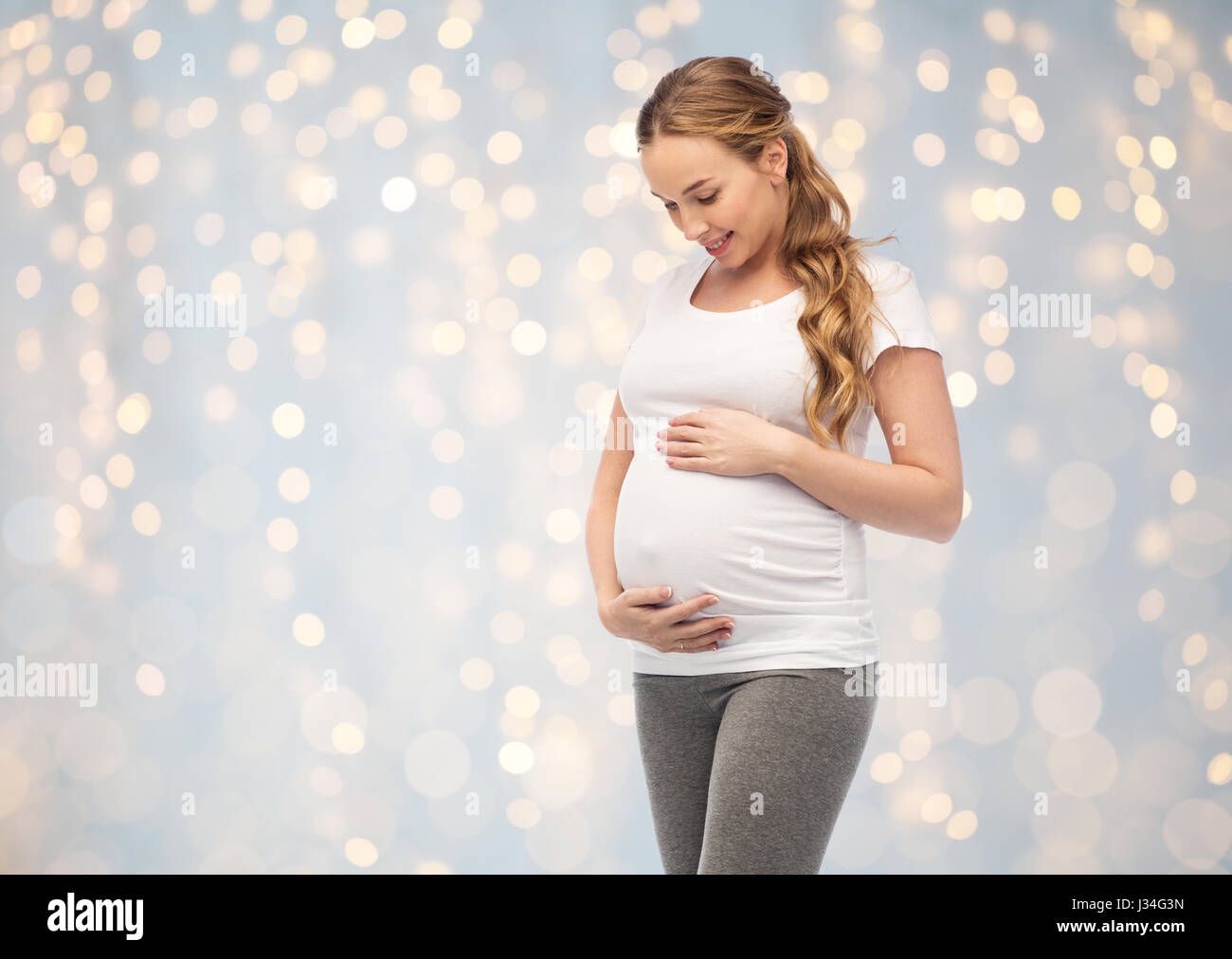 happy pregnant woman touching her big belly Stock Photo - Alamy