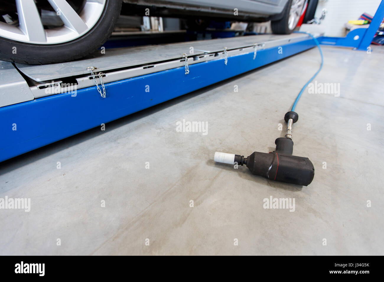 screwdriver and car at tire shop Stock Photo - Alamy