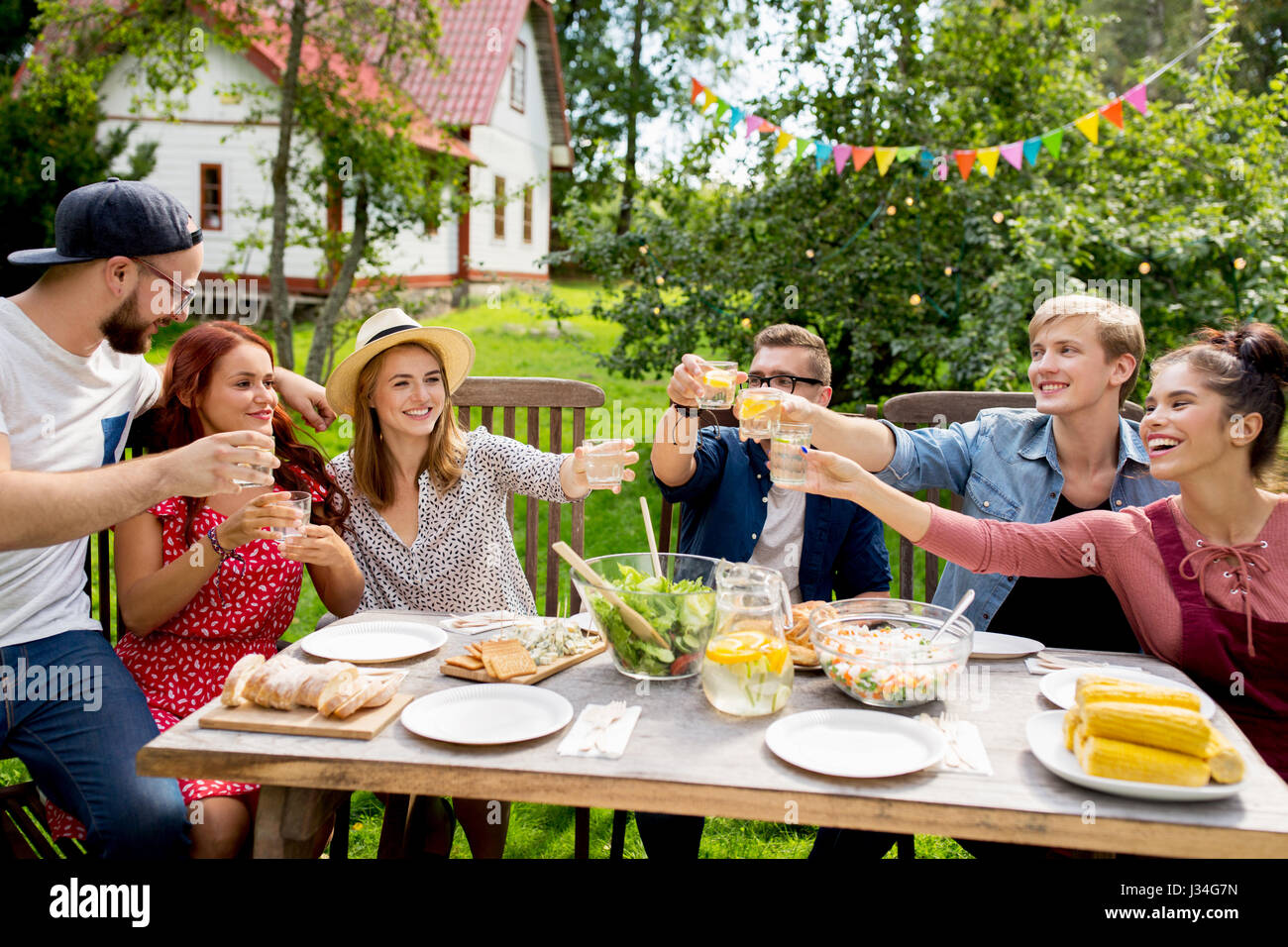 happy friends having party at summer garden Stock Photo - Alamy
