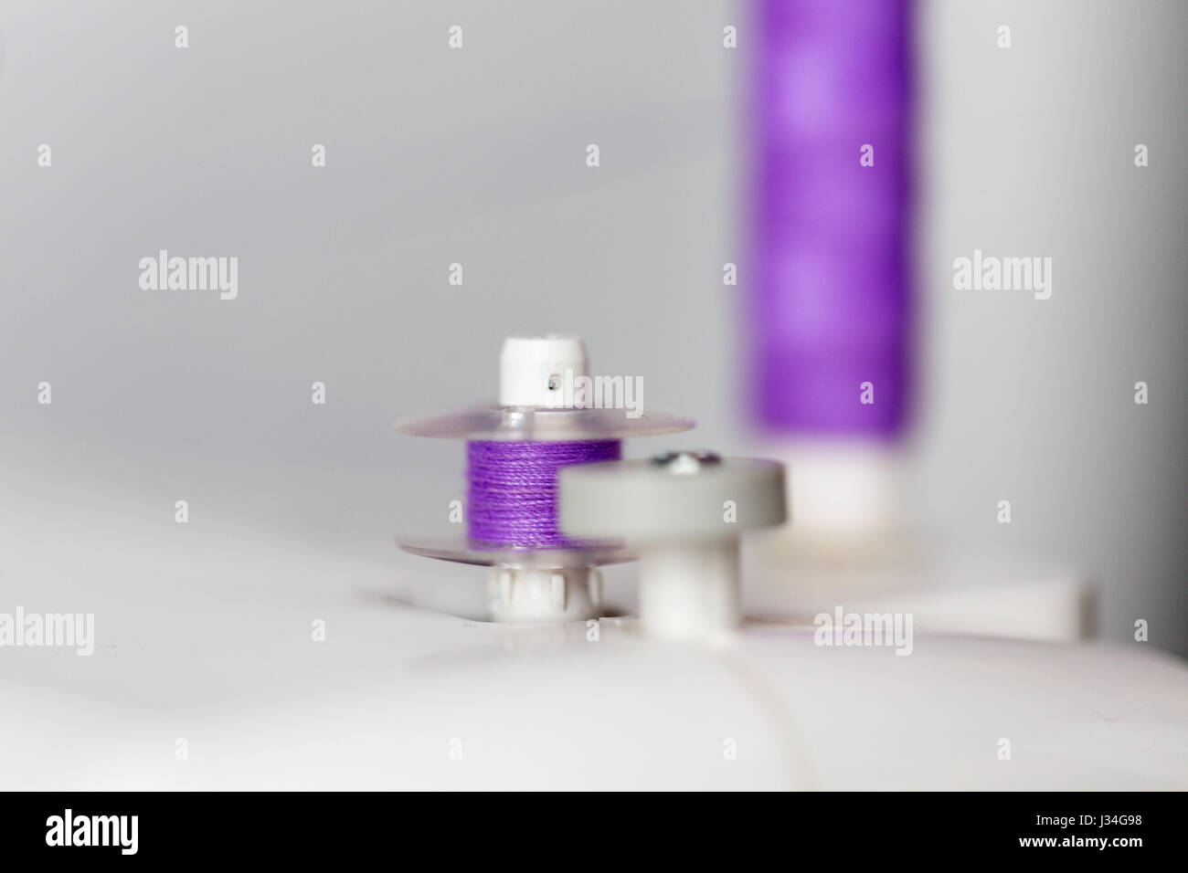 thread spools on sewing machine Stock Photo - Alamy