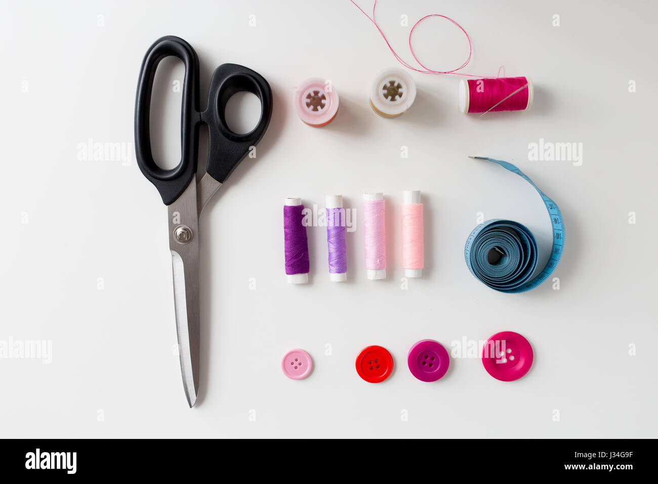 scissors, sewing buttons, threads and tape measure Stock Photo - Alamy