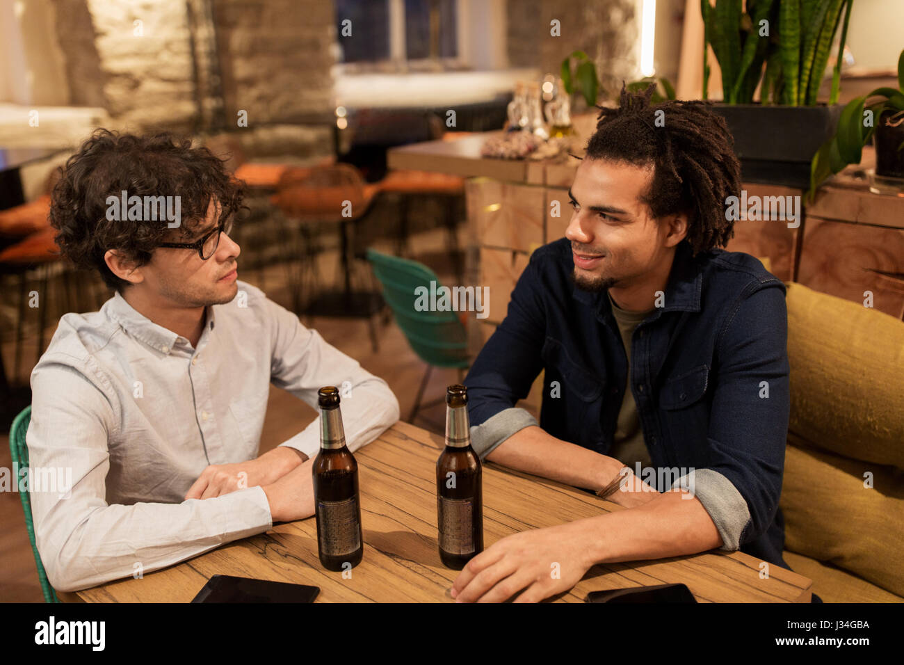 happy male friends drinking beer at bar or pub Stock Photo - Alamy
