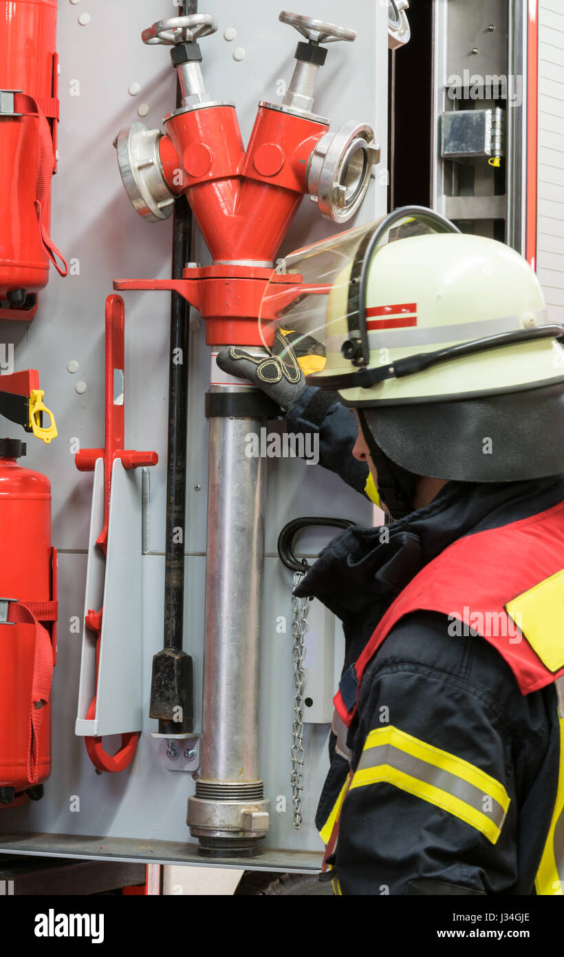 Firefighter works on the fire engine Stock Photo - Alamy
