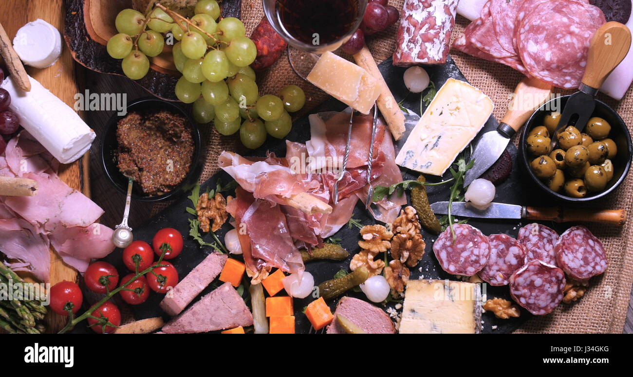 Top down view of a platter of cured meat (charcuterie), ham, salami ...