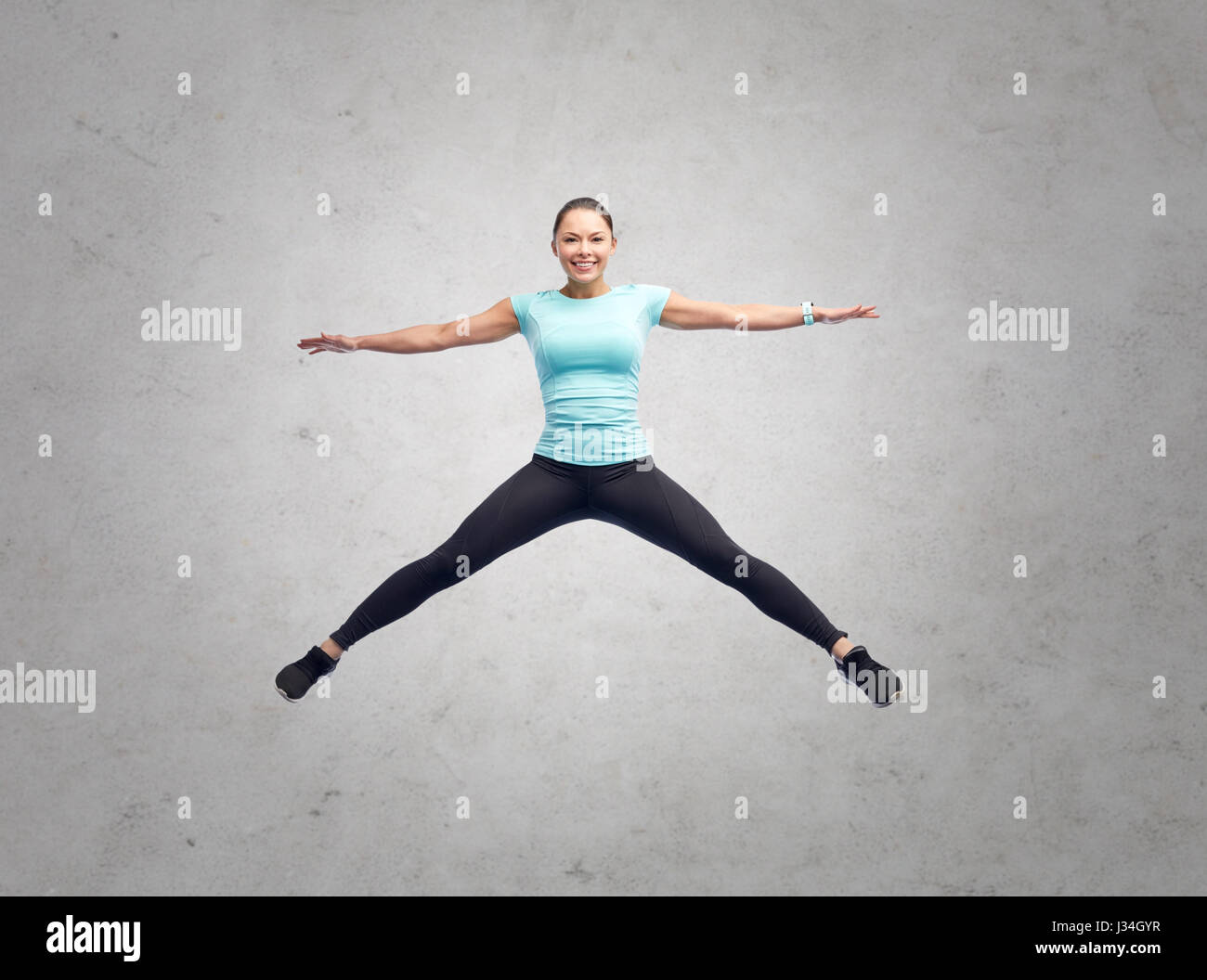 Young woman jumping concrete wall hi-res stock photography and images ...