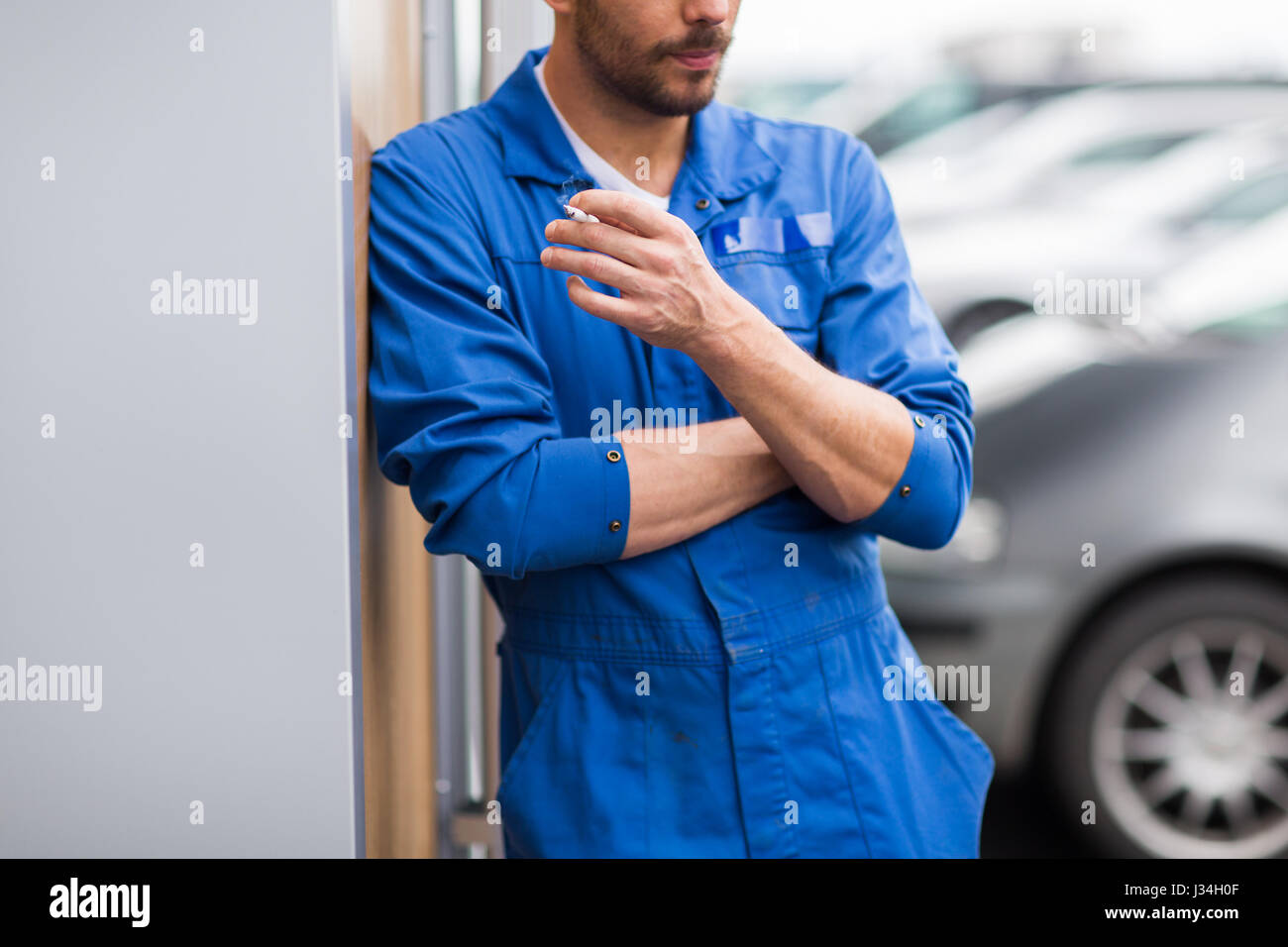 close up of auto mechanic smoking cigarette Stock Photo - Alamy