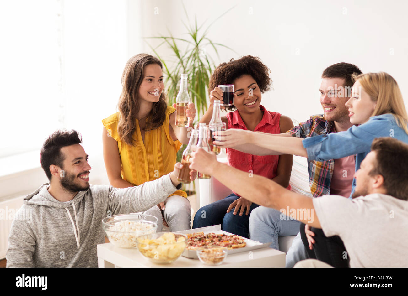 friends having party and clinking drinks at home Stock Photo - Alamy