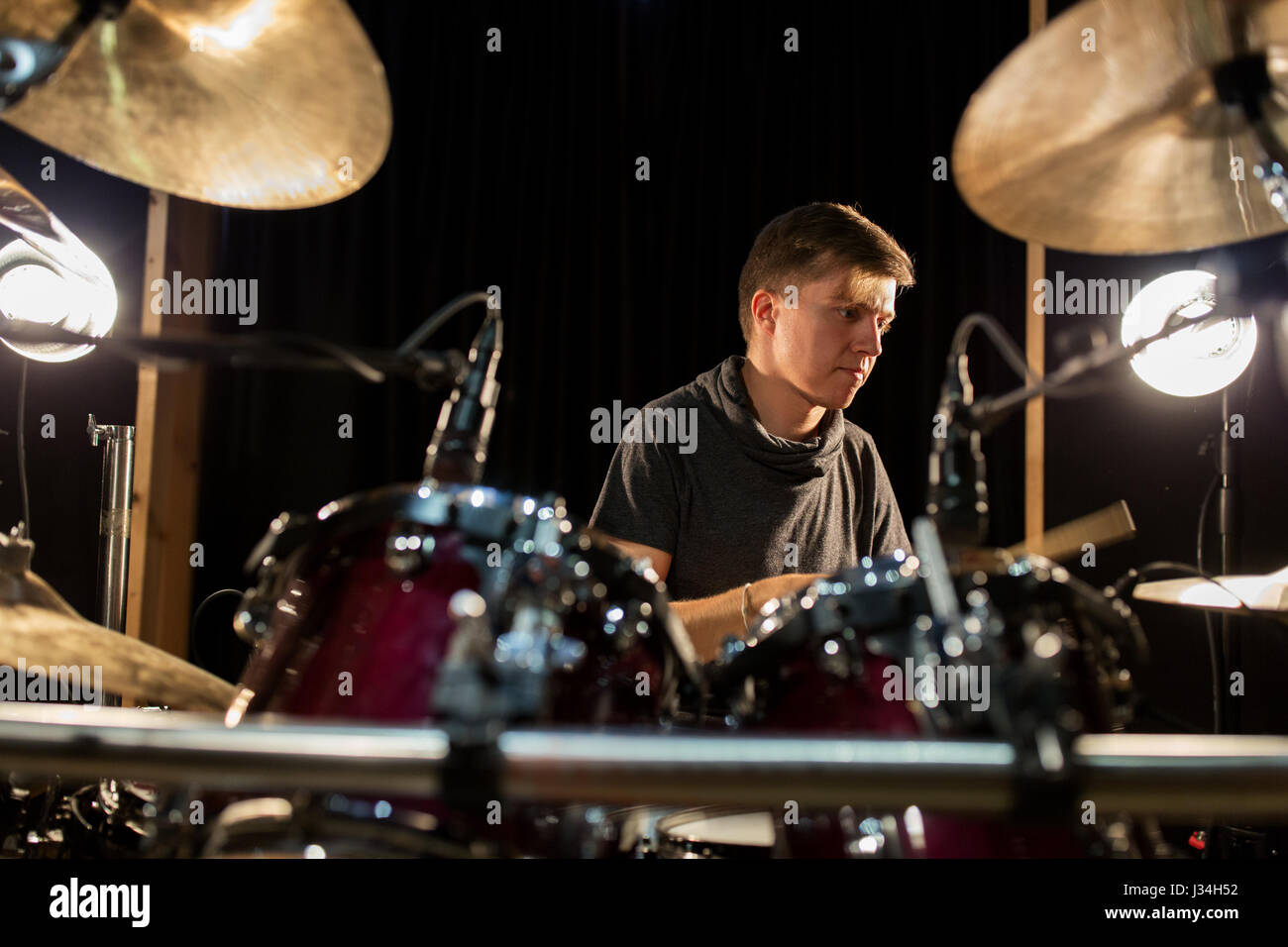 male musician playing drums and cymbals at concert Stock Photo - Alamy