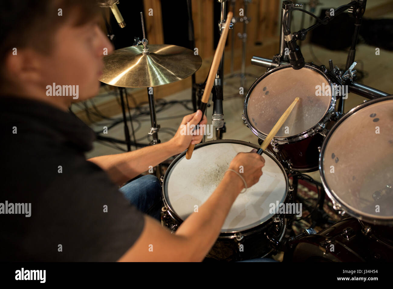 male musician playing drums and cymbals at concert Stock Photo - Alamy