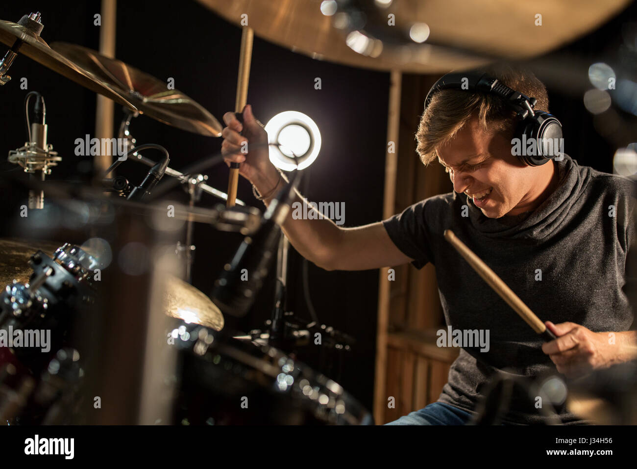 male musician playing drums and cymbals at concert Stock Photo - Alamy