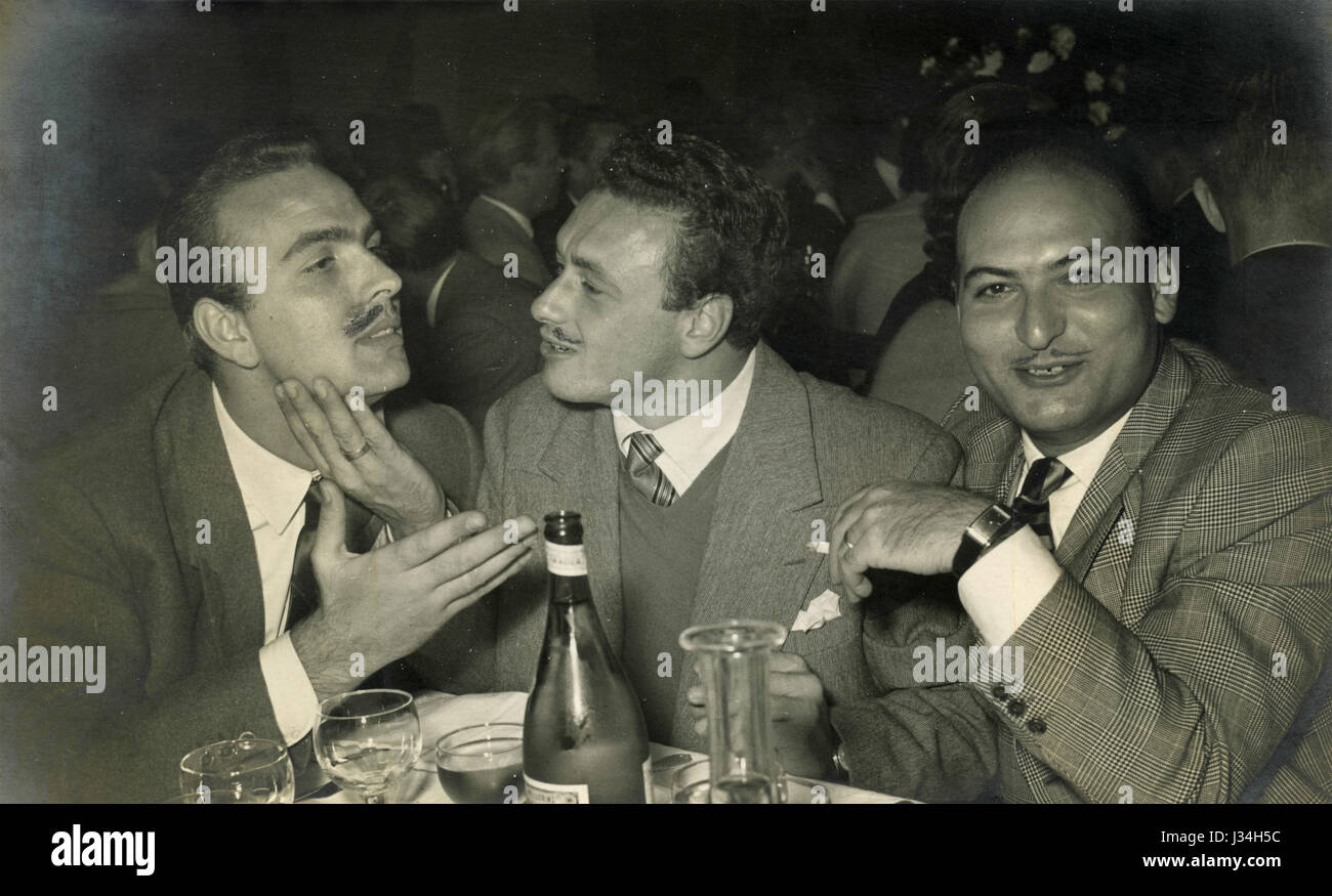 Three men enjoying at the restaurant, Italy 1956 Stock Photo - Alamy