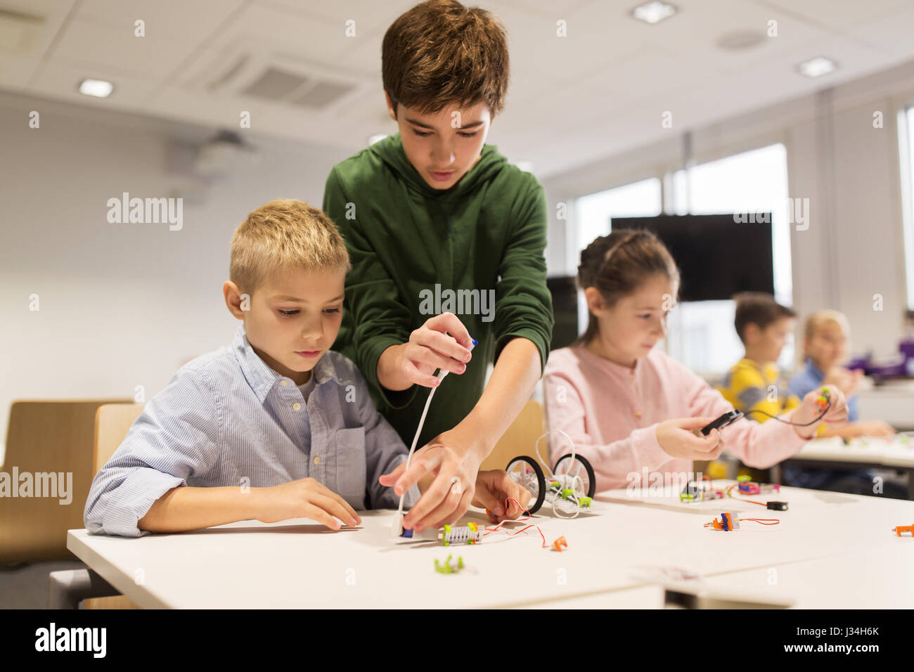 happy children building robots at robotics school Stock Photo - Alamy