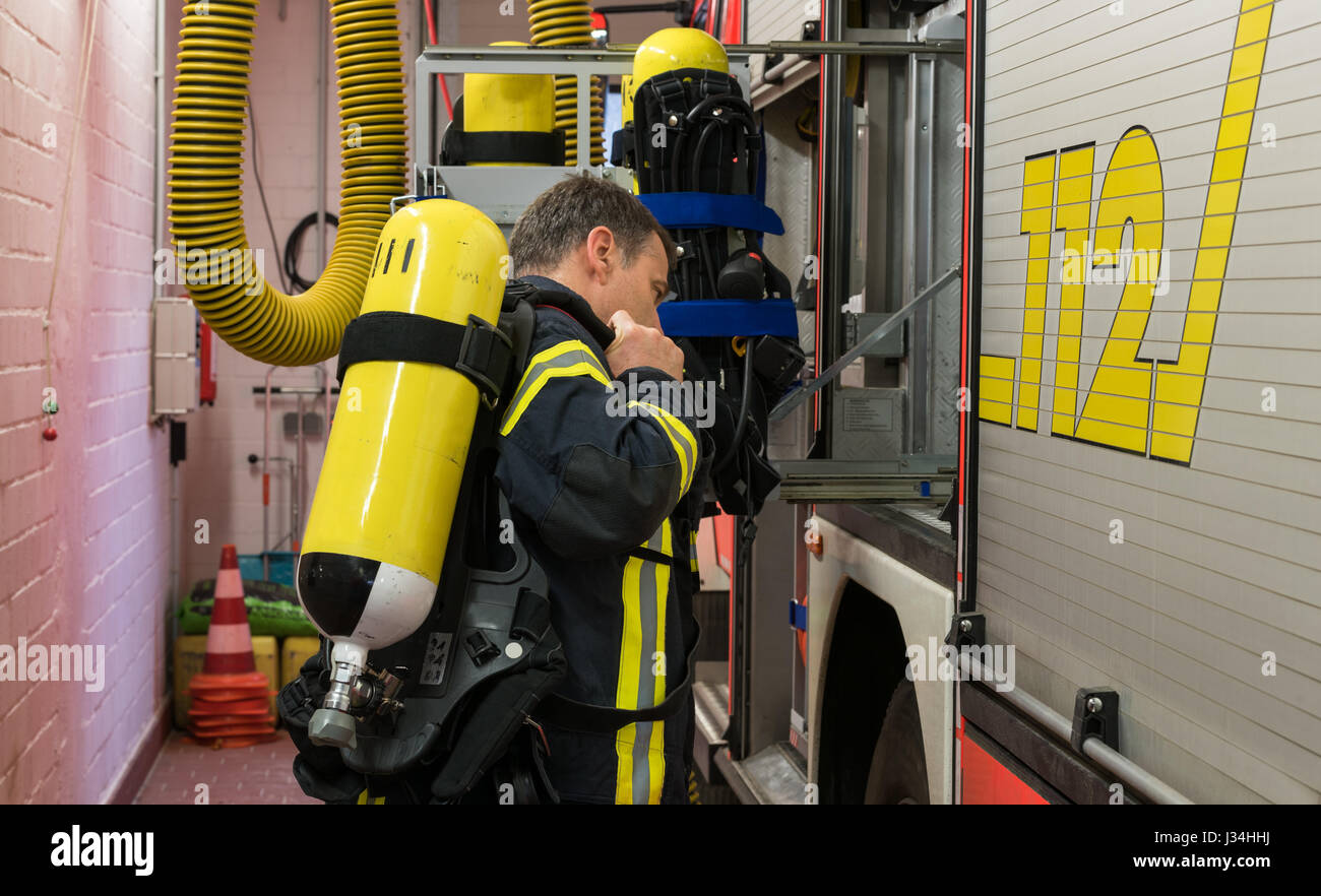 German Firefighter in action with oxygen tank Stock Photo - Alamy