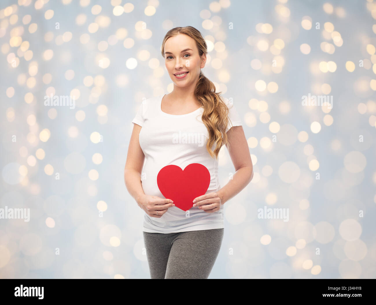 happy pregnant woman with red heart Stock Photo - Alamy