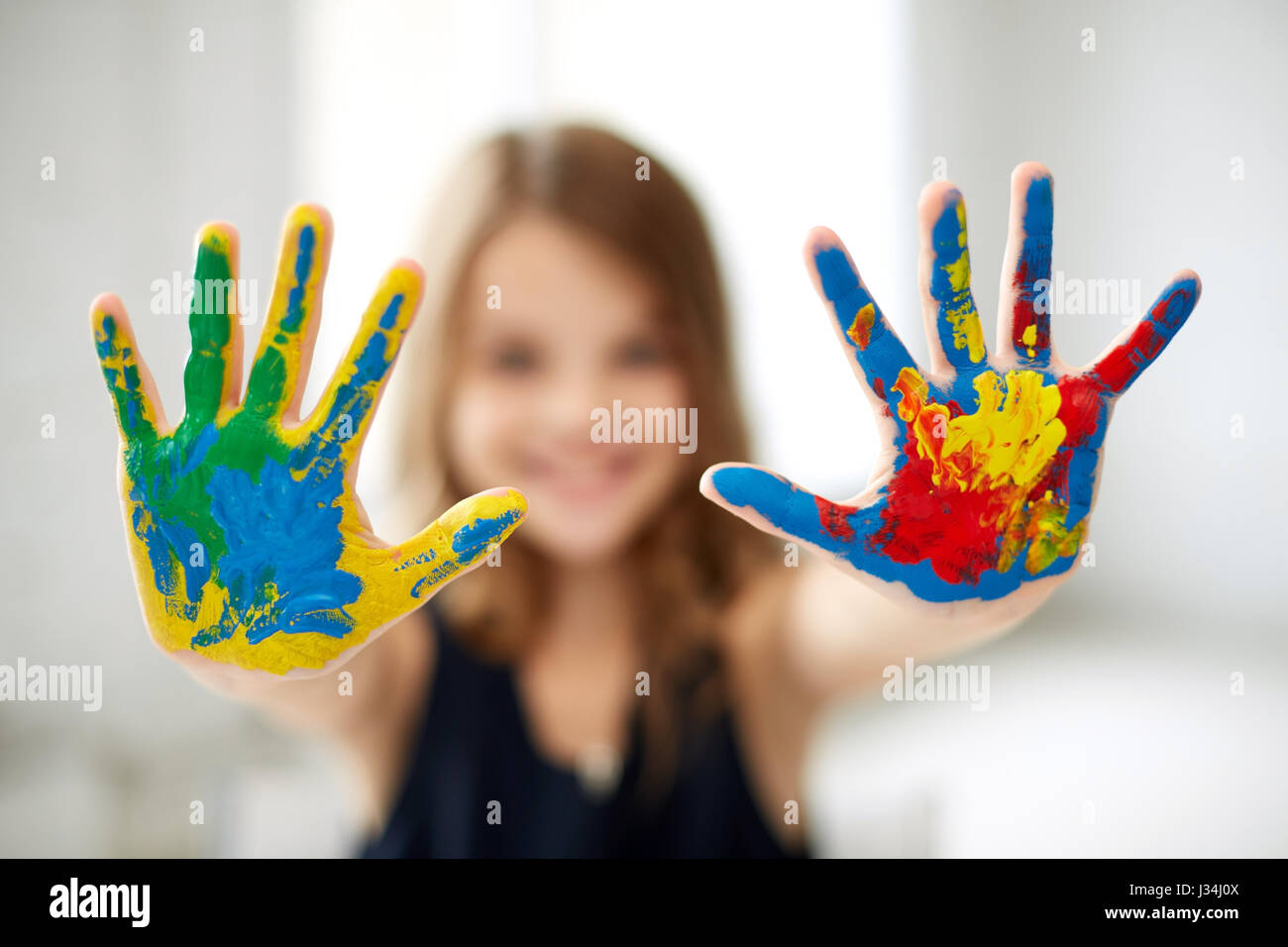 girl showing colored hands Stock Photo - Alamy