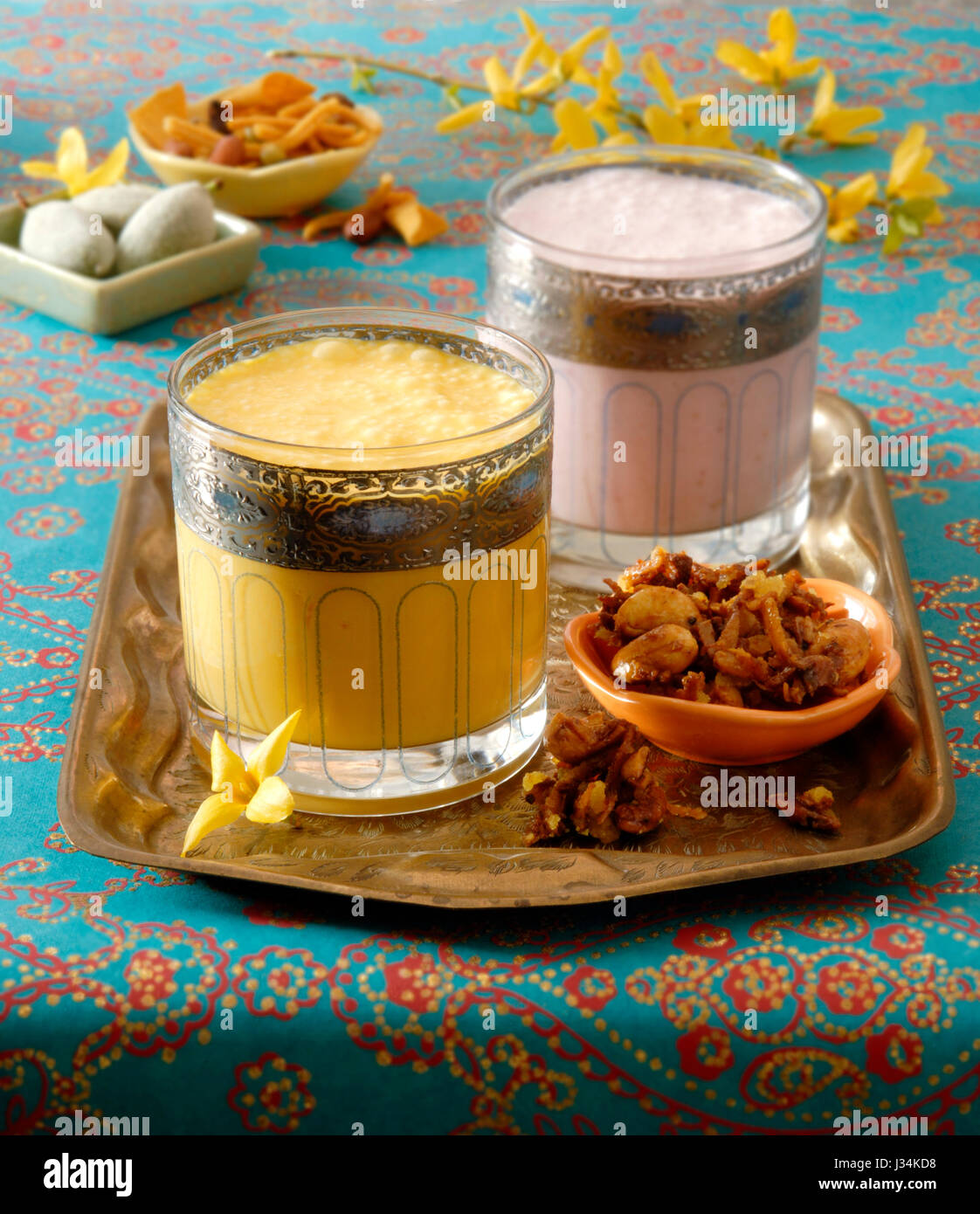 Mango and Strawberry Lassi in glasses on a silver tray, in a Bollywood ...